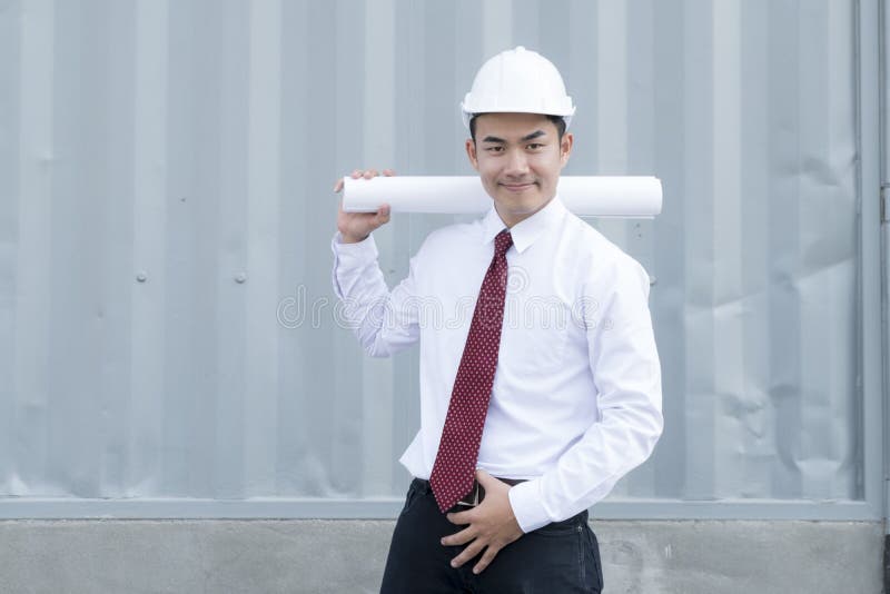 Young Engineer with Paper Plans. Stock Photo - Image of housing, design ...