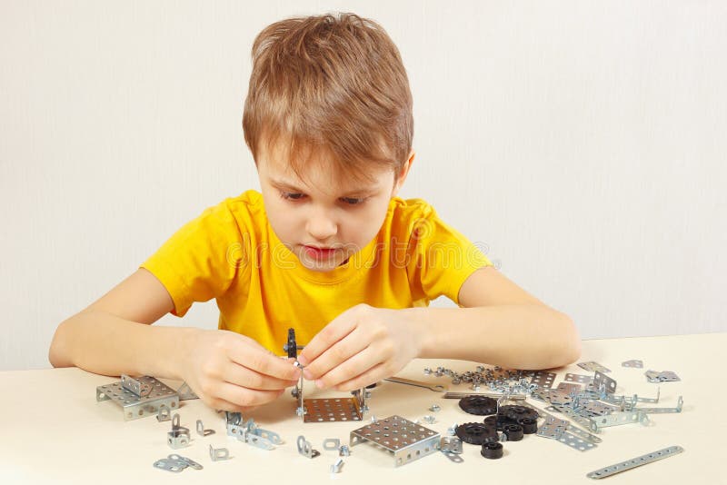 Young Engineer Plays with Mechanical Starter Kit at Table Stock Image ...