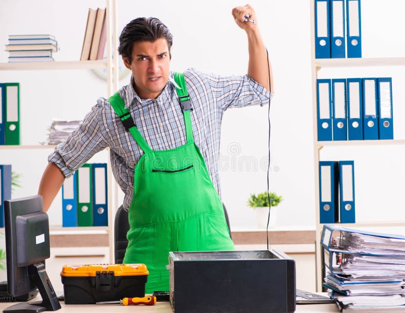 Young Engineer Repairing Broken Computer at the Office Stock Image ...