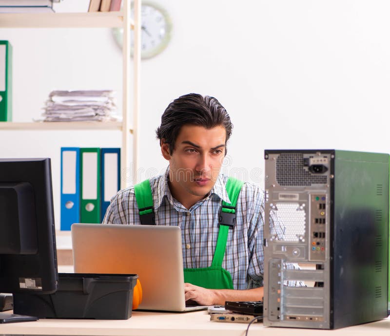 Young Engineer Repairing Broken Computer at the Office Stock Image ...
