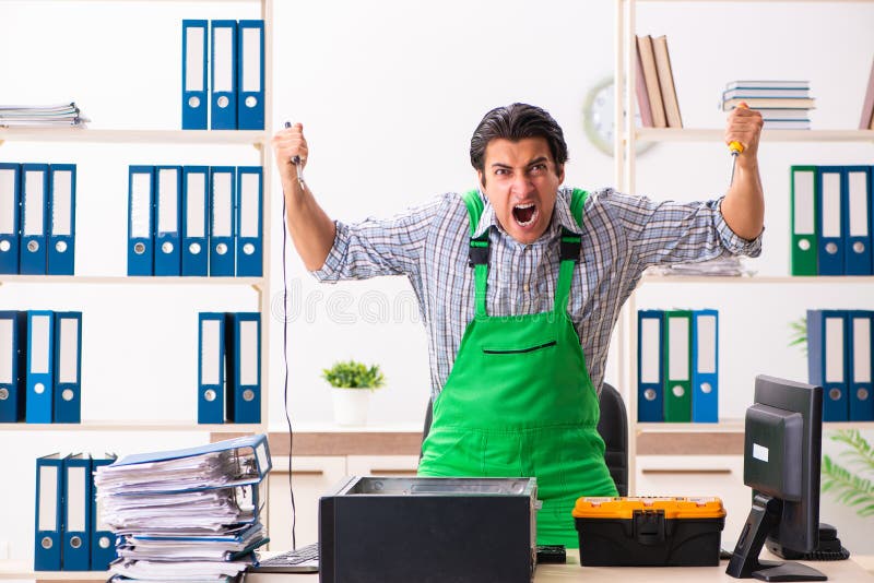 The Young Engineer Repairing Broken Computer at the Office Stock Image ...