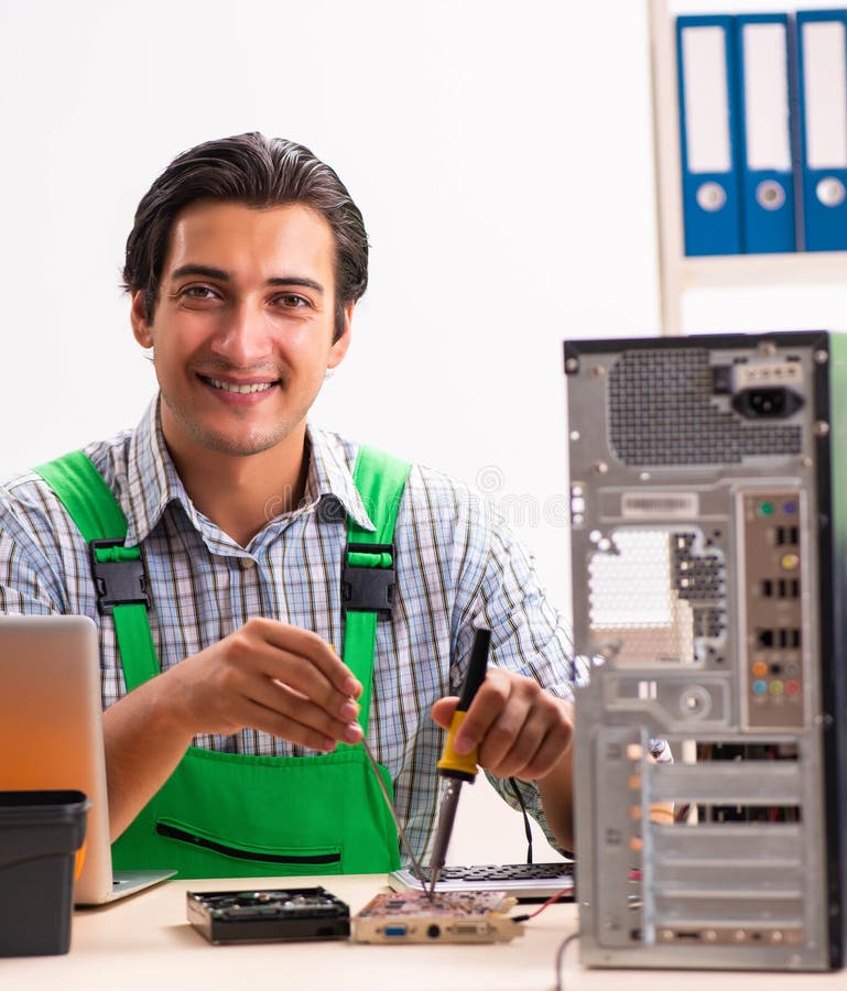 Young Engineer Repairing Broken Computer at the Office Stock Image ...