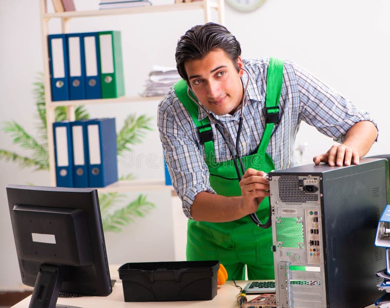 Young Engineer Repairing Broken Computer at the Office Stock Image ...