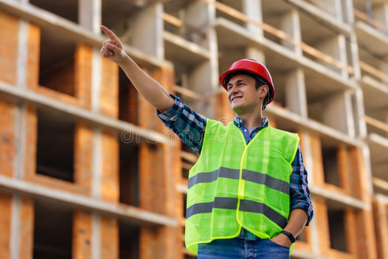 Young Engineer Showing Something at Building Site Stock Photo - Image ...