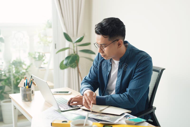 Young Engineer. Successful Busy Man Drawing Something while Working in ...