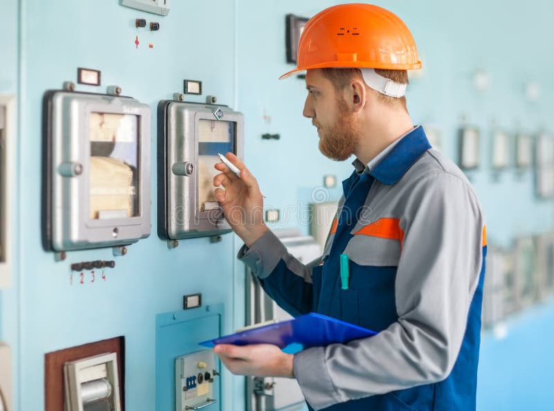 Young Engineer Taking Notes at Control Room Stock Photo - Image of ...