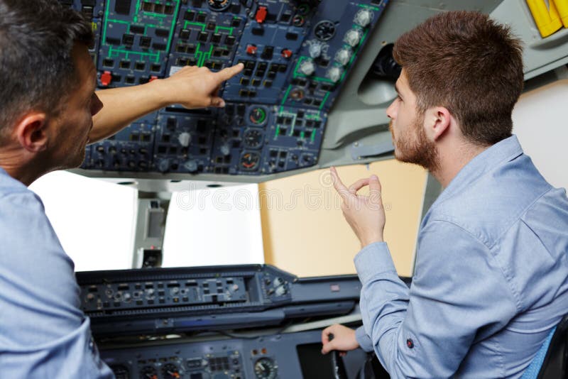Young Engineer Training in Aircraft Cockpit Stock Photo - Image of back ...