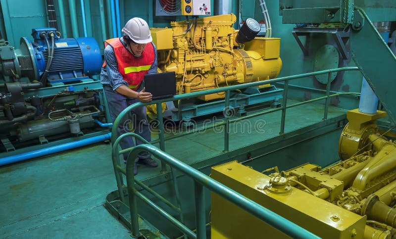 Young Engineer Using Laptop Computer To Checking Engine Quality System ...