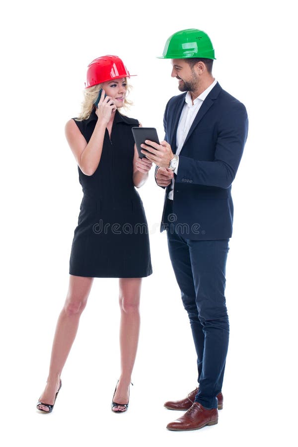Young Engineer Woman and Woman in Helmet Communicating by Mobile Stock ...