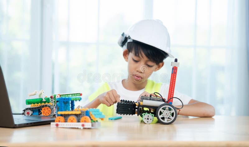 Young Engineer at Work: a Focused Young Boy, Wearing a Safety Hard Hat ...