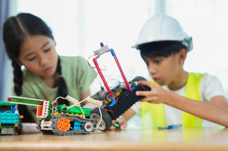 Young Engineer at Work: a Focused Young Boy, Wearing a Safety Hard Hat ...
