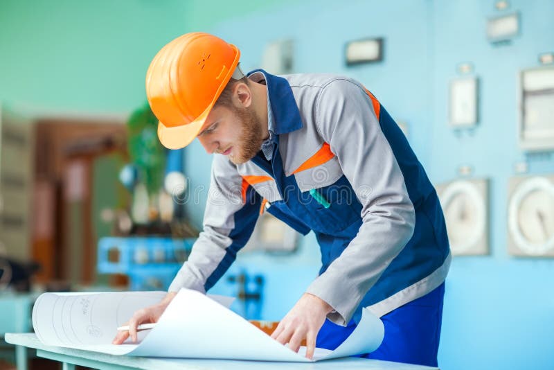 Young Engineer Working with Blueprint at Control Room Stock Image ...