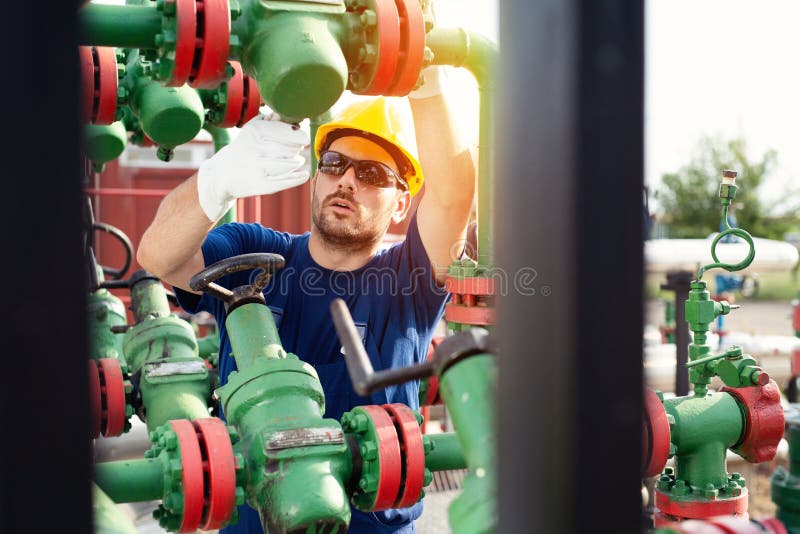 Oil Worker is Checking the Oil Pump on the Sunset Background Stock ...