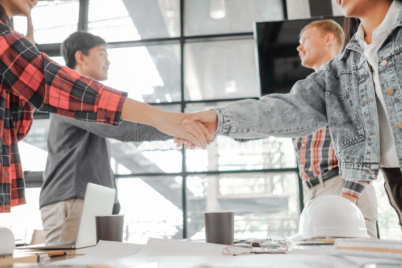 Young Engineers Partners Shaking Hands after Complete Agreement ...