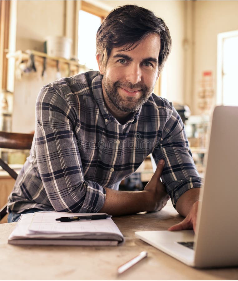 Young Entrepreneur Using a Laptop in His Workshop Stock Photo - Image ...