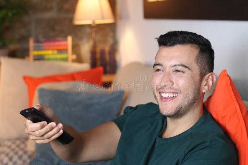 Young Ethnic Man Watching Tv Stock Image - Image of couch, home: 198160501