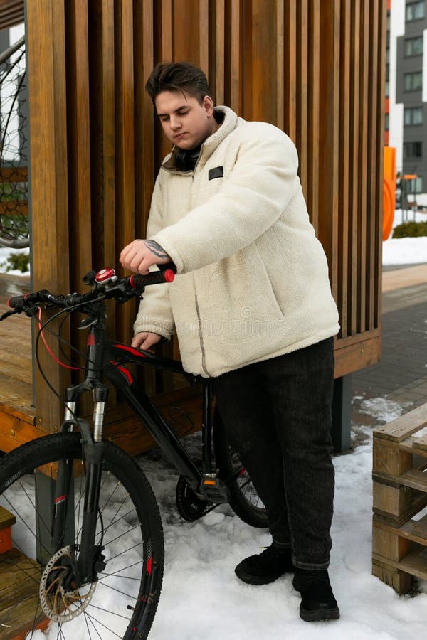 Cute Young Guy Riding a Bike Around the City in Winter Stock Photo ...