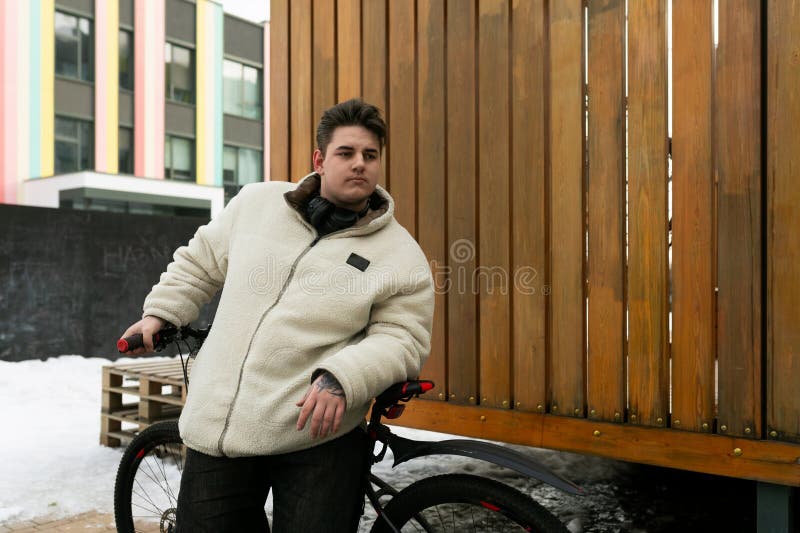 Cute Young Guy Riding a Bike Around the City in Winter Stock Photo ...