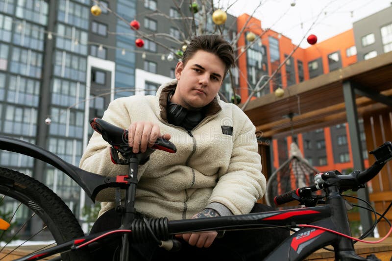 Cute Young Guy Riding a Bike Around the City in Winter Stock Photo ...