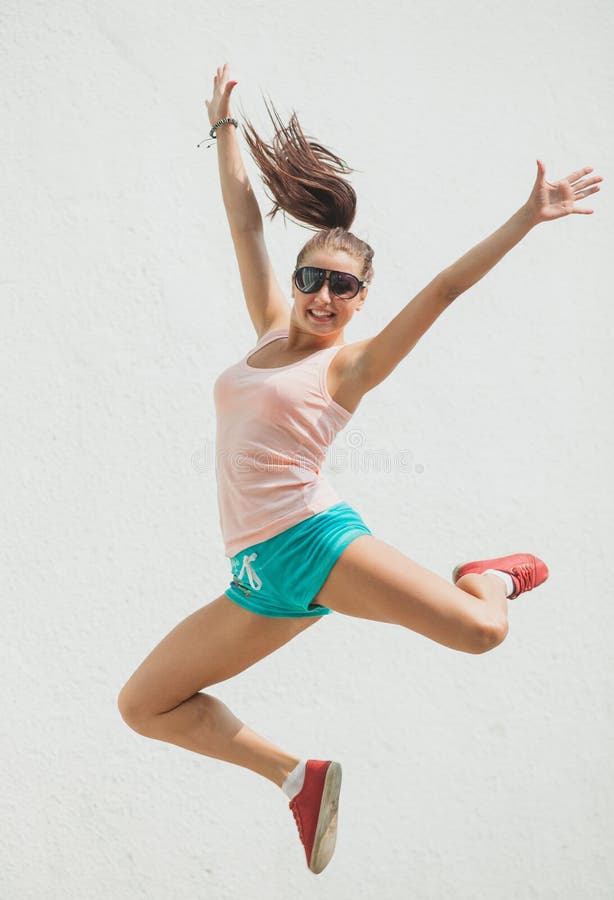 Young excited girl jumping stock photo. Image of expression - 32868494