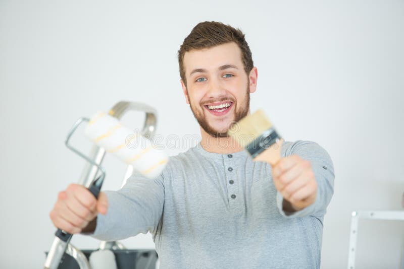 Young Excited Man Holding Paint Brush and Smiling Stock Image - Image ...