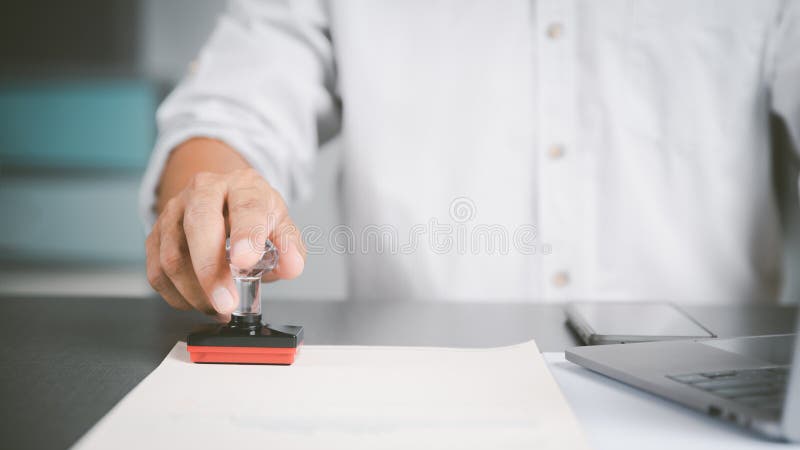 A Young Executive is Stamping on Documents for a Business Contract ...