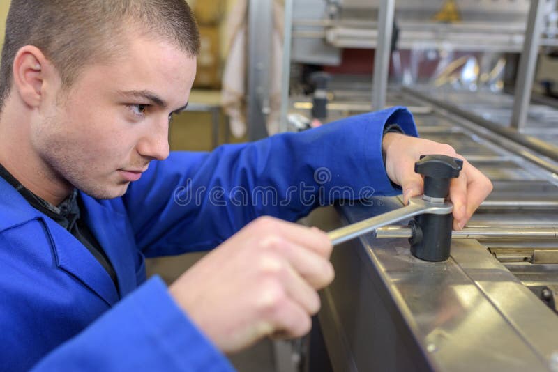 Young Factory Worker Operating Machine Stock Image - Image of safety ...