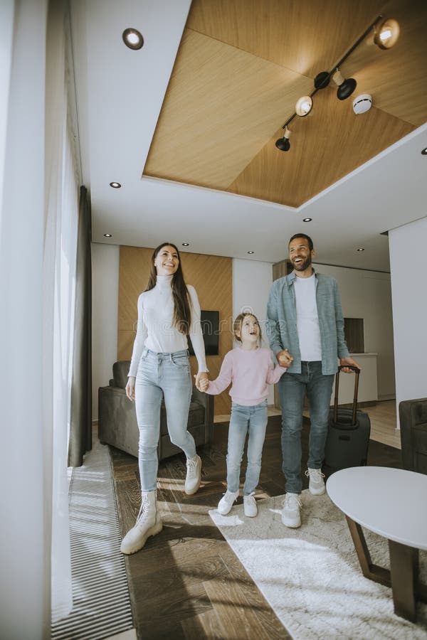 Young Family Arrive into Hotel Room Stock Photo - Image of together ...