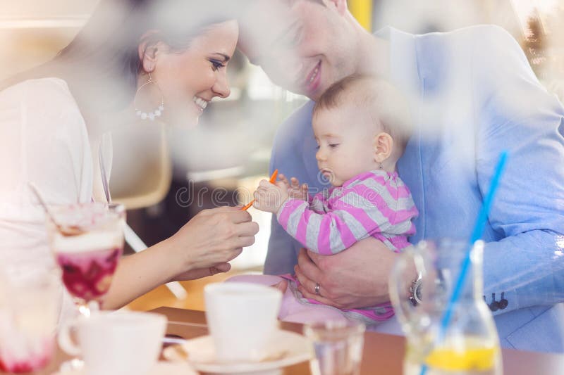 Young family in cafe stock photo. Image of enjoying, beautiful - 61184576