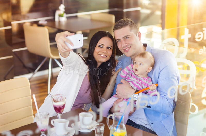 Young family in cafe stock image. Image of beautiful - 61184875
