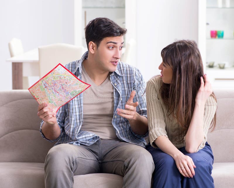 Young Family Discussing Travel Plans with Map Stock Photo - Image of ...