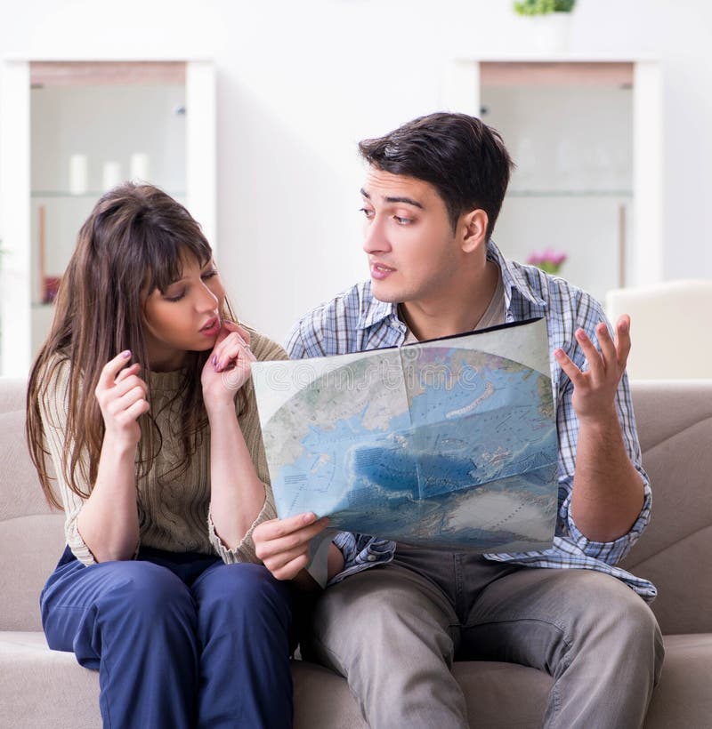 Young Family Discussing Travel Plans with Map Stock Image - Image of ...