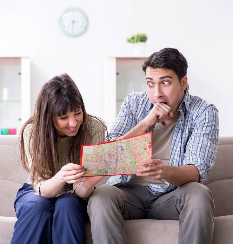 Young Family Discussing Travel Plans with Map Stock Image - Image of ...