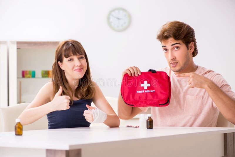 The Young Family Getting Treatment with First Aid Kit Stock Image ...