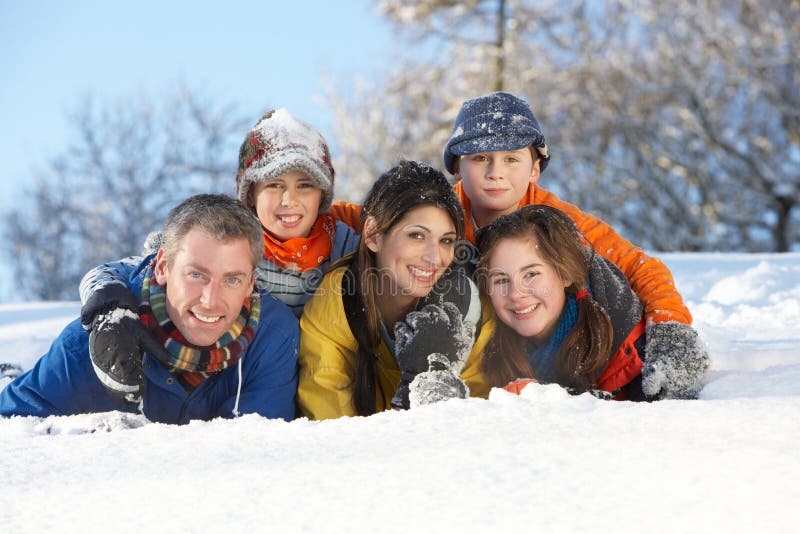 Young Family Having Fun in Snowy Landscape Stock Image - Image of lying ...