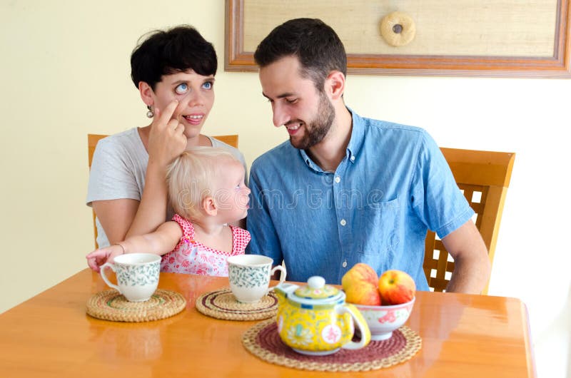 Young Family at Home on the Weekend. Family Drinking Tea. Stock Photo ...