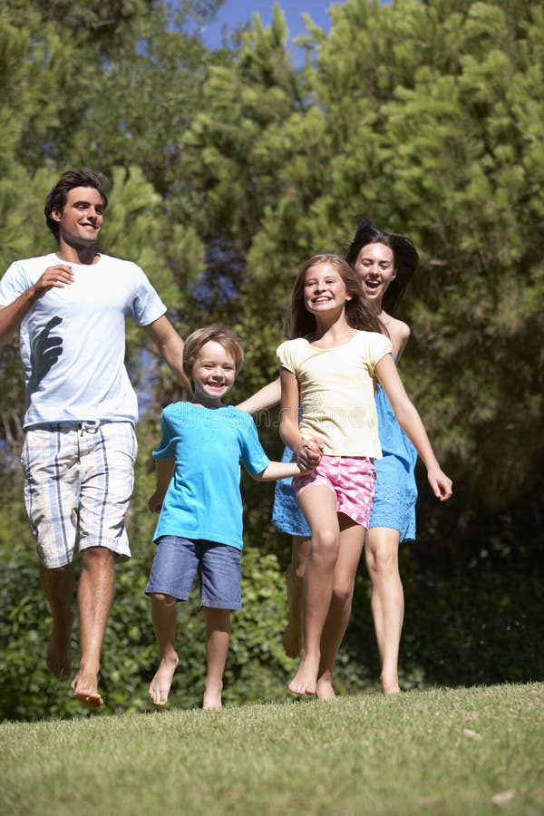 Young Family Running through Summer Field Stock Photo - Image of active ...