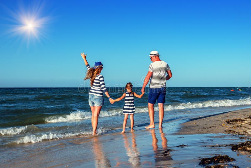 Young Family on the Sea Shore Stock Image - Image of ocean, girl: 126724167