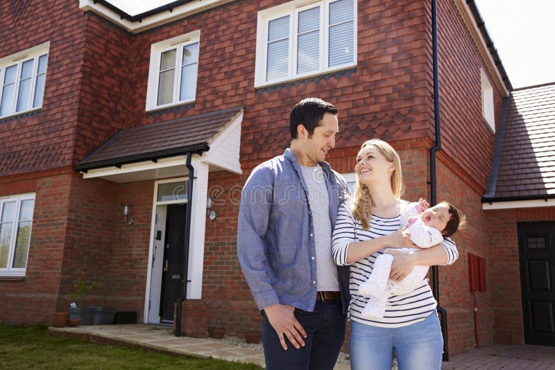 Young Family Standing Outside New Home Stock Photo - Image of real ...