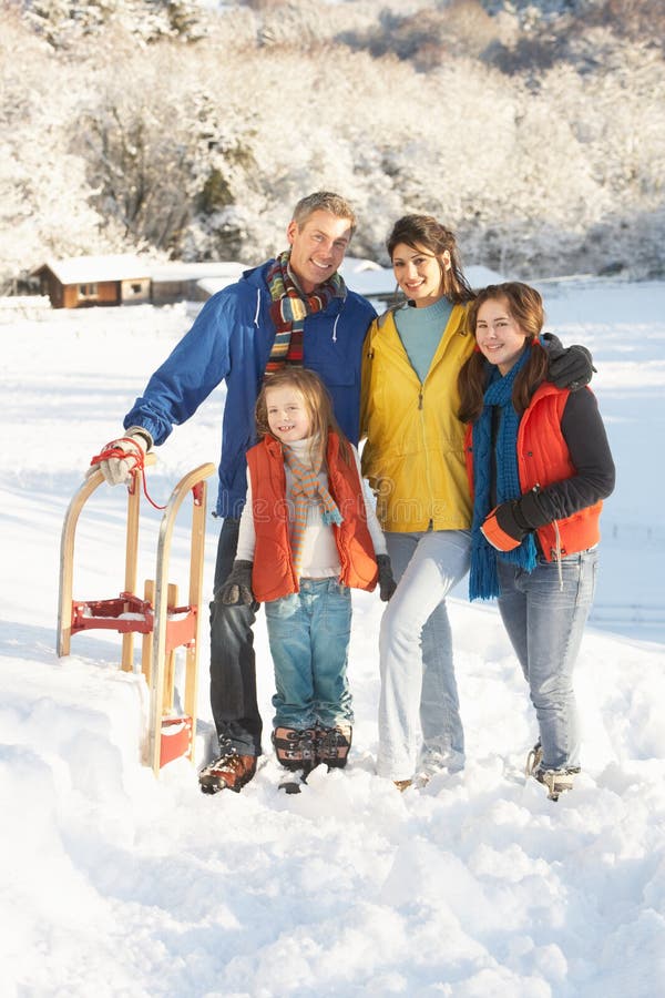 Young Family Standing in Snowy Landscape Stock Photo - Image of ...