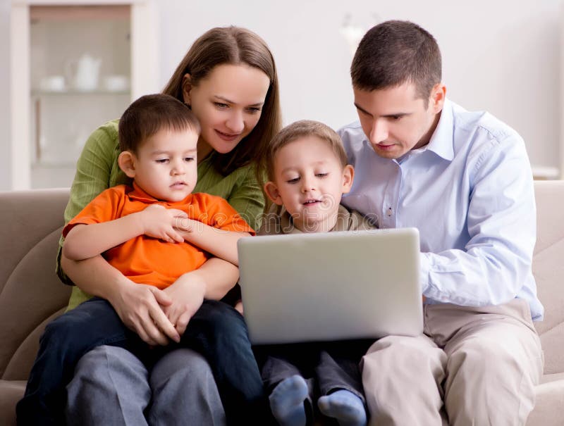 Young Family Surfing Internet and Looking at Photos Stock Photo - Image ...