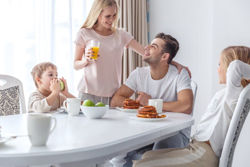 Young Family Taking Breakfast Together Stock Photo - Image of indoor ...