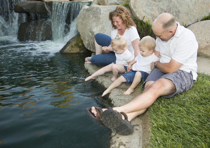 Young Family with Twins Enjoy Water in Park Stock Image - Image of ...