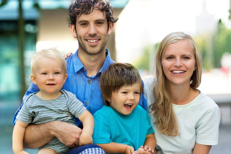 Young family with two kids stock image. Image of father - 62605399
