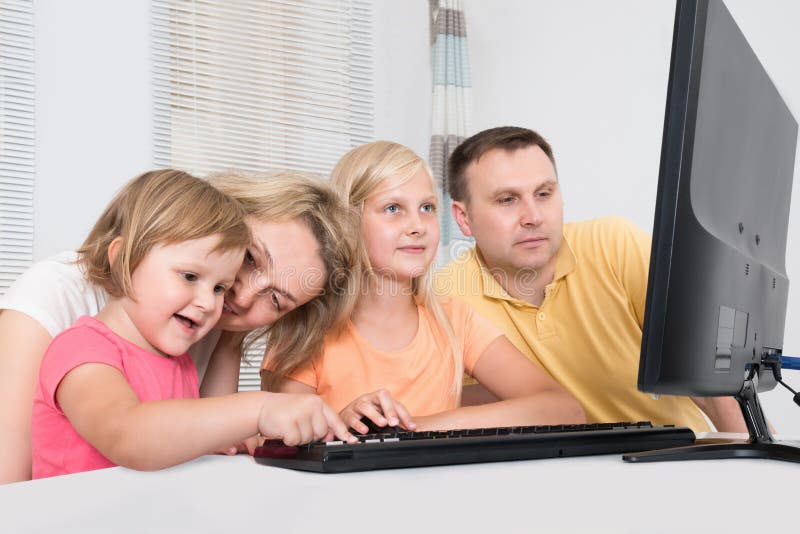Young Family Using Computer Together Stock Image - Image of family ...