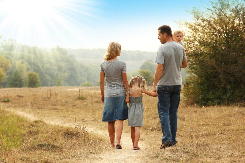 Young family walk together stock photo. Image of watching - 75809868