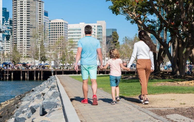 Young Family Walking in Park with Son Back View, Parents Stock Image ...
