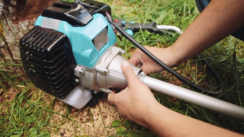 Young Farmer Assembles Brush Cutter Engine. Stock Photo - Image of ...