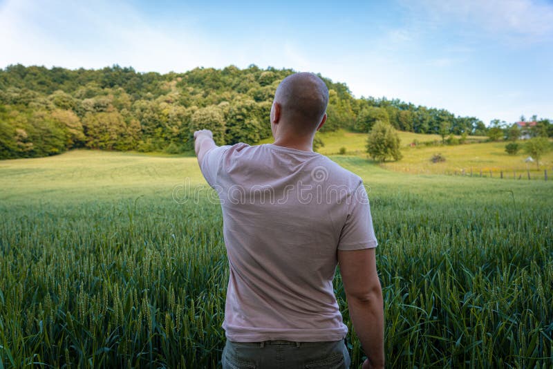 Young Farmer Pointing at Something in the Distance Stock Photo - Image ...