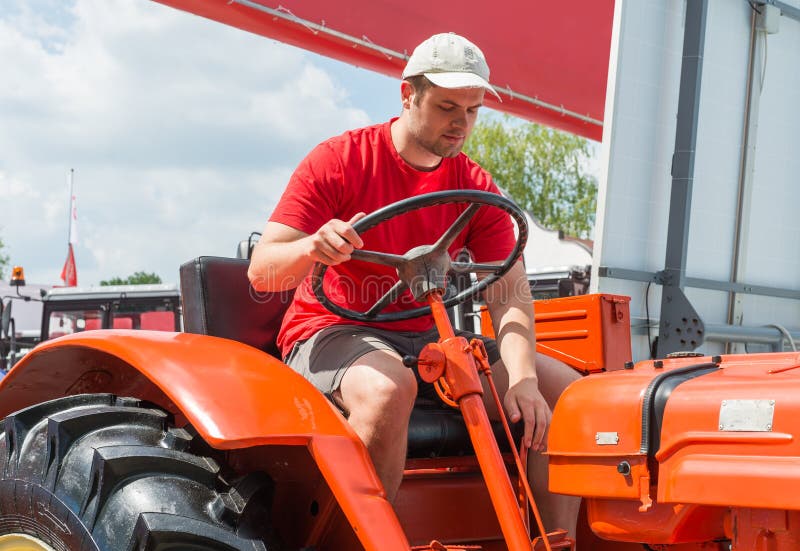 Young farmer in tractor stock image. Image of vehicle - 64206035